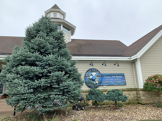 Catfish Charlie's welcomes you with casual charm, its blue spruce standing guard like a Midwest sentinel protecting seafood treasures within.