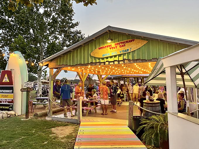 Rainbow-colored picnic tables create a beachside paradise where your toes can wiggle in the sand while your taste buds dance with delight.