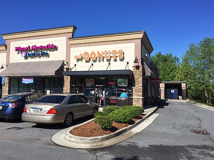 The siren call of that "Donuts" sign hits different at 7am &ndash; Ray's storefront promises morning salvation in strip mall form.