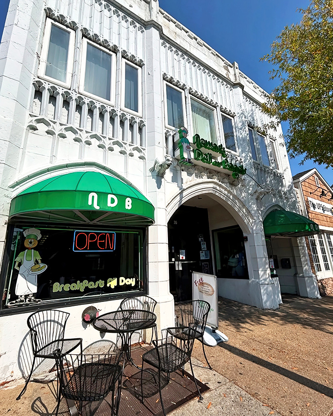 The distinctive white facade with emerald green awnings of Newark Deli & Bagels stands out like a culinary beacon on Main Street.