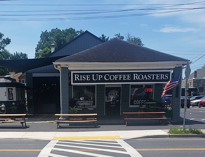 The Eastern Shore's coffee sanctuary beckons with rustic picnic tables and an American flag, promising caffeinated salvation for weary travelers.