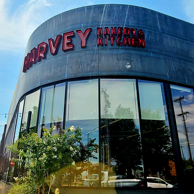 The curved modernist facade of Harvey Bakery & Kitchen stands as a bold architectural statement, its red signage beckoning hungry Oklahomans like a breakfast lighthouse.