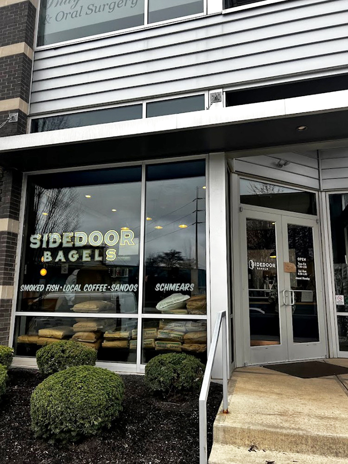 The unassuming exterior of Sidedoor Bagel belies the culinary treasures within. Those flour bags in the window? That's a promise, not decoration.