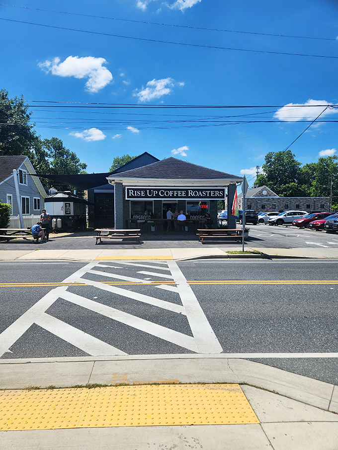 The Eastern Shore's coffee sanctuary beckons with rustic picnic tables and an American flag, promising caffeinated salvation for weary travelers.