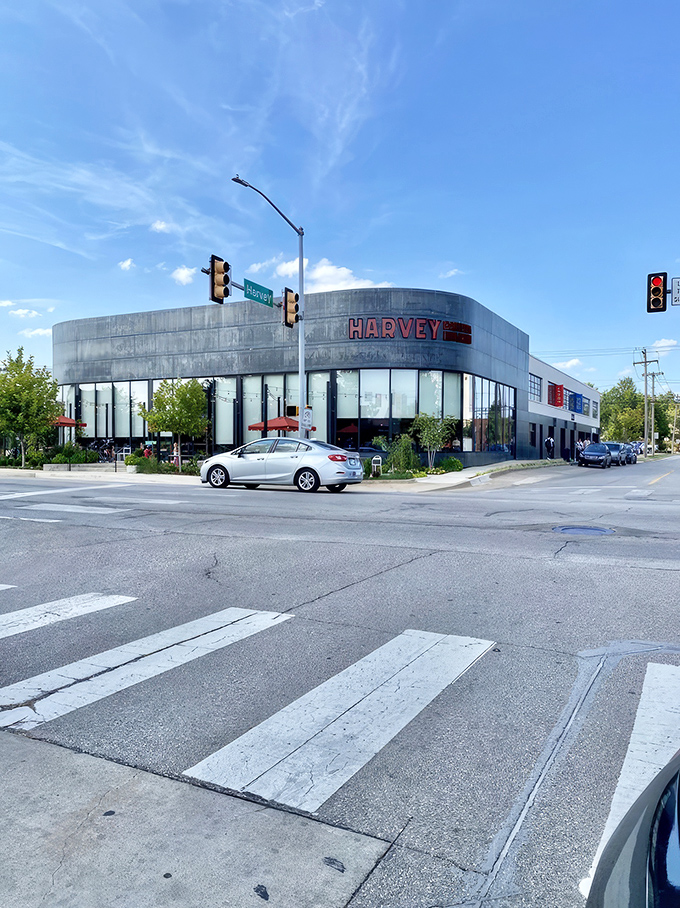 The curved modernist facade of Harvey Bakery & Kitchen stands as a bold architectural statement, its red signage beckoning hungry Oklahomans like a breakfast lighthouse.