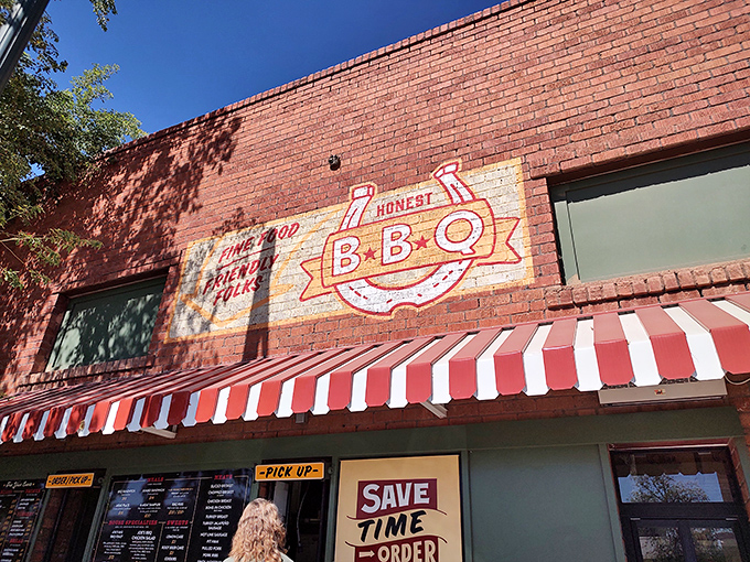 The brick facade of Joe's Real BBQ stands proudly on Gilbert's main drag, Arizona flags flanking its name like sentinels guarding a smoky treasure.