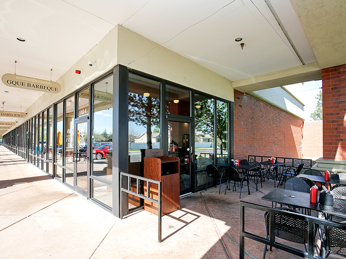 GQue's unassuming storefront hides barbecue greatness like a superhero's secret identity. The real magic happens behind those glass doors.