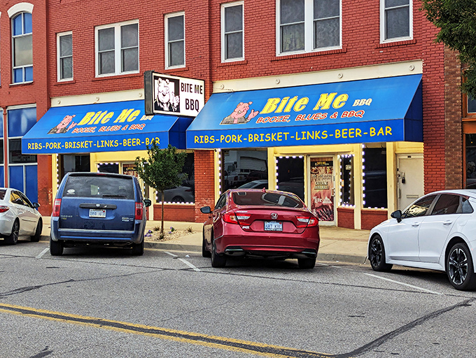 The bright blue awning of Bite Me BBQ stands out like a beacon of smoky hope on Wichita's St. Francis Street, promising delicious rebellion in every bite.