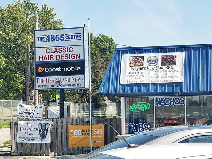 The blue exterior of Wayne's New Skoo BBQ beckons like a smoke signal to hungry travelers. This unassuming strip mall spot proves Nebraska's barbecue scene is no flyover affair.