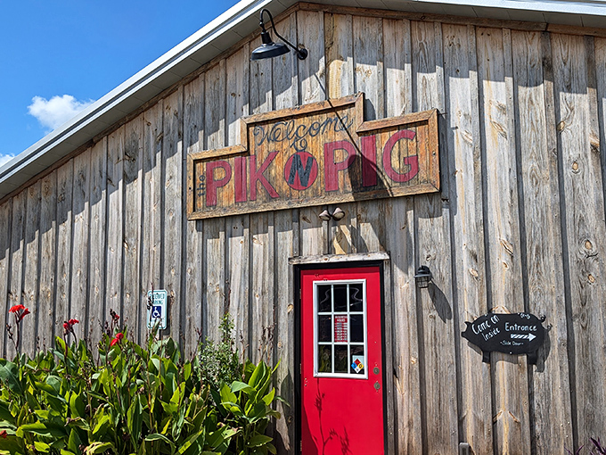 The weathered wooden exterior with its vibrant red door isn't just rustic charm&mdash;it's a barbecue beacon calling hungry pilots and road-trippers alike.