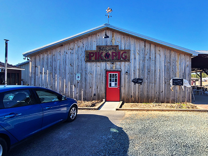 The weathered wooden exterior with its vibrant red door isn't just rustic charm&mdash;it's a barbecue beacon calling hungry pilots and road-trippers alike.