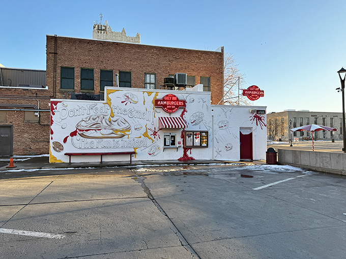 The humble white facade of Cozy Inn, where culinary magic has happened since the Roaring Twenties. "Don't fear the smell, the fun is inside!"