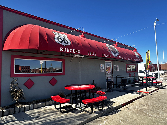 The modest exterior with its vibrant red awning and Route 66 shield promises more than meets the eye&mdash;culinary magic happens inside these unassuming walls.