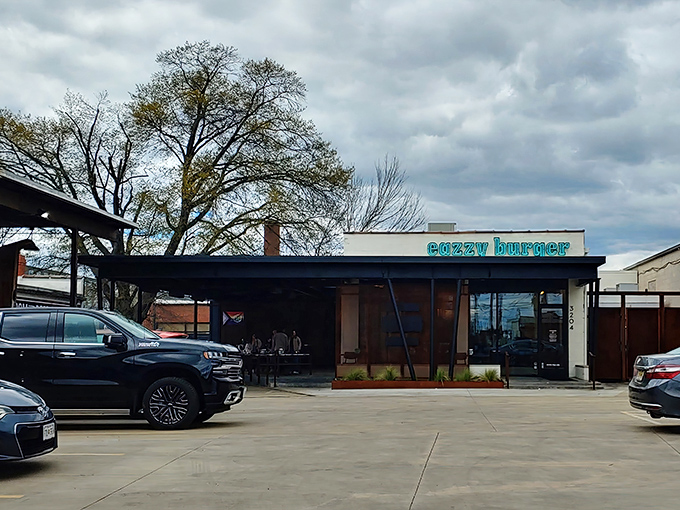 That turquoise neon sign against the white building isn't just a beacon for hungry travelers&mdash;it's a promise of burger nirvana waiting inside.