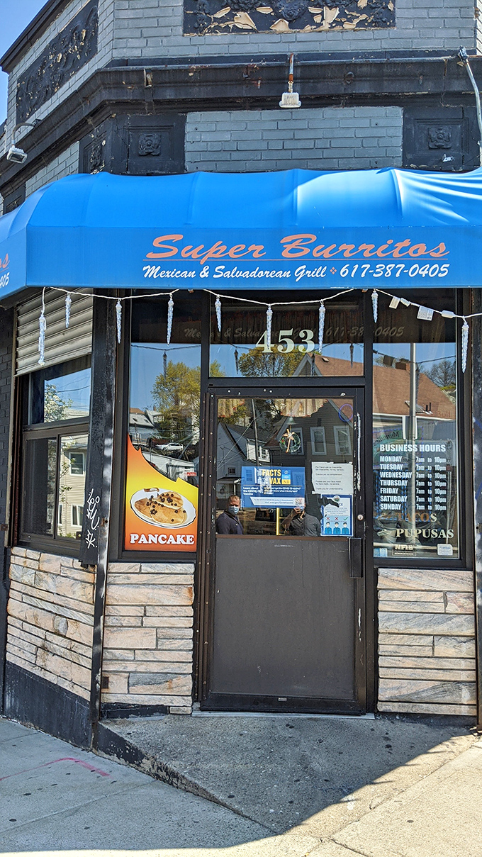 The iconic Super Burrito's sign glows like a beacon of hope for hungry travelers. That cartoon chef knows what you're craving before you do.
