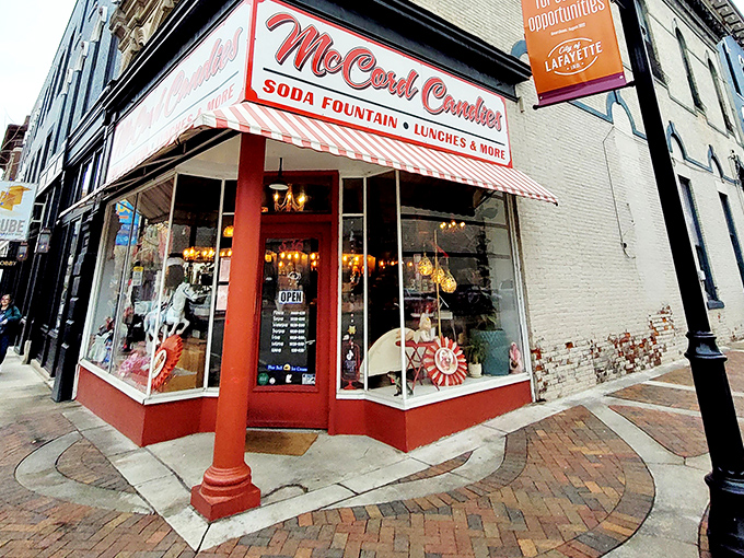 The iconic red and white striped awning of McCord Candies stands like a beacon of sweetness on Lafayette's Main Street, inviting passersby into a world of nostalgic treats.