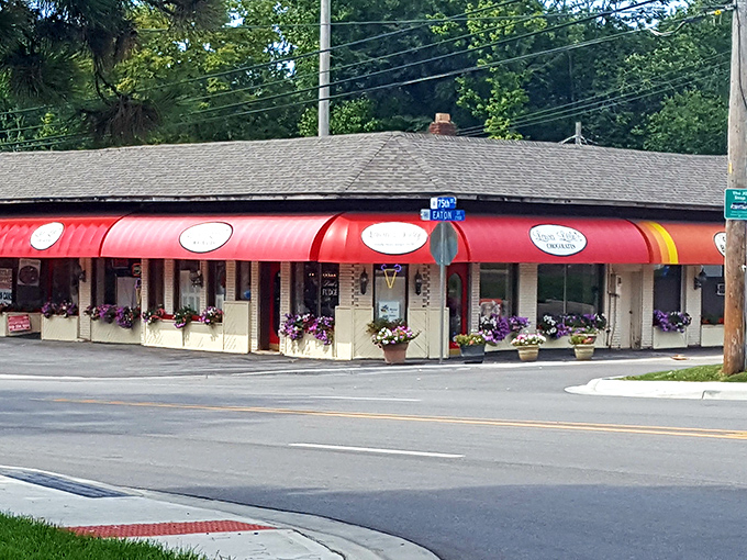 The iconic red awning of Laura Little's Candy Kitchen beckons like a sweet siren call, promising sugary treasures within this Prairie Village landmark.