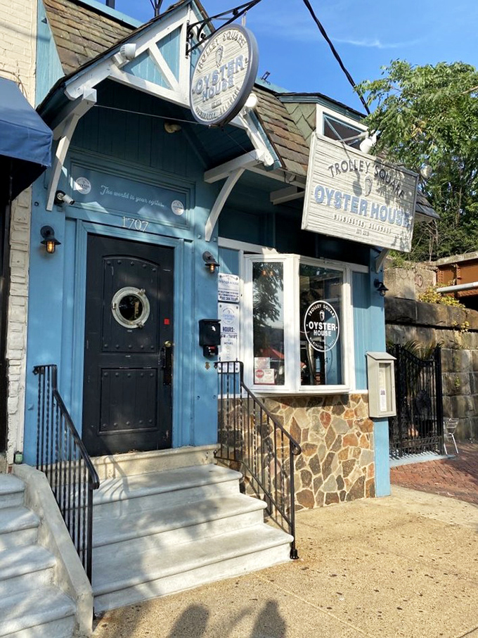 The blue fa&ccedil;ade of Trolley Square Oyster House stands like a maritime beacon in Wilmington, promising seafood treasures within those weathered wooden signs.