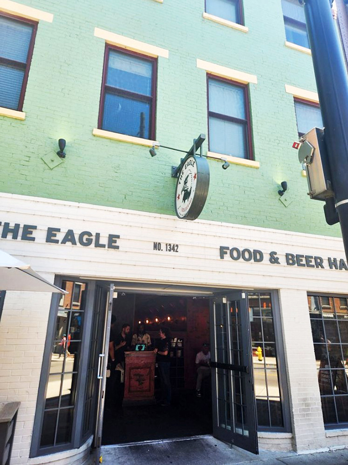 The mint-green facade of The Eagle OTR stands like a beacon of culinary promise in Cincinnati's historic district, its unassuming exterior hiding delicious secrets within.