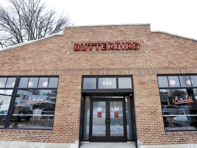 The glowing "BUTTERBIRD" sign against brick is Madison's bat signal for fried chicken enthusiasts. Simple, unassuming, and hiding delicious secrets within.