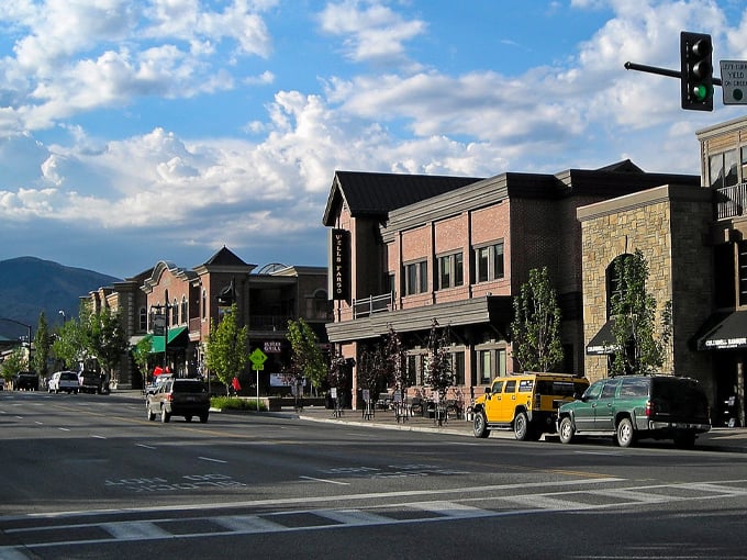 Historic brick buildings line Ketchum's charming streets, where spring blossoms frame architecture that whispers stories of Idaho's mining past.