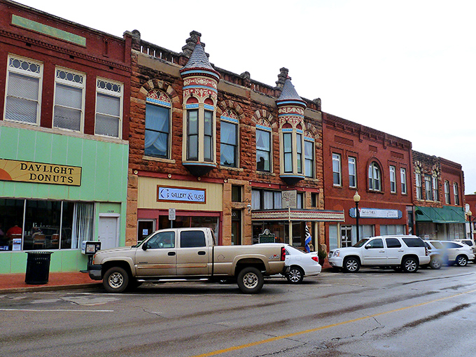 Guthrie's Victorian storefronts stand proudly like architectural time travelers. That mint-green Daylight Donuts sign promises sweet rewards for early risers.