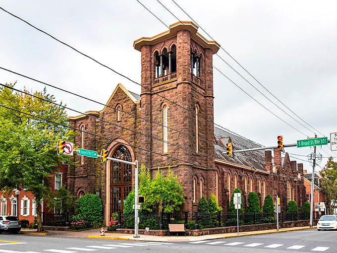 The historic Moravian Church stands as Lititz's architectural crown jewel, its brownstone tower reaching skyward like a sentinel guarding the town's rich heritage.