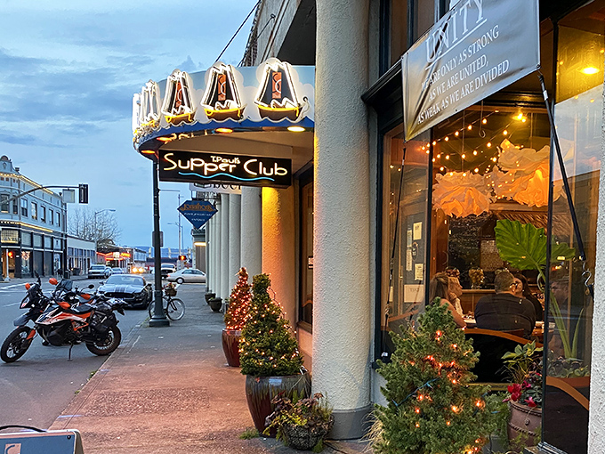 The blue awning with sailing ships beckons like a lighthouse for hungry souls. Astoria's historic charm meets culinary adventure at T. Paul's entrance.