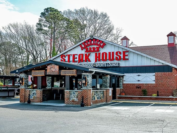 The iconic red neon sign of Aberdeen Barn glows against the twilight sky, a beacon for hungry travelers and locals alike seeking steakhouse perfection.