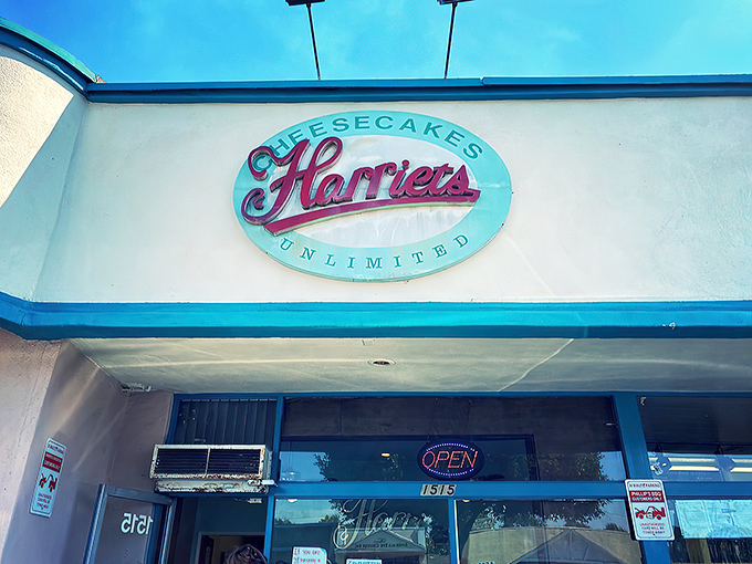 The unassuming storefront of Harriet's Cheesecakes Unlimited in Inglewood &ndash; proof that culinary greatness often hides in plain sight behind modest blue trim.