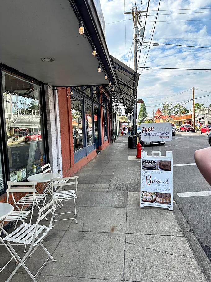 The storefront beckons with its charming simplicity, promising sweet treasures within. That "Free Cheesecake Samples" sign is the culinary equivalent of a siren song. 