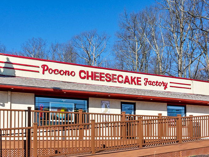 The unassuming exterior of Pocono Cheesecake Factory beckons like a dessert oasis in the woods. Sweet treasures await behind that burgundy sign.