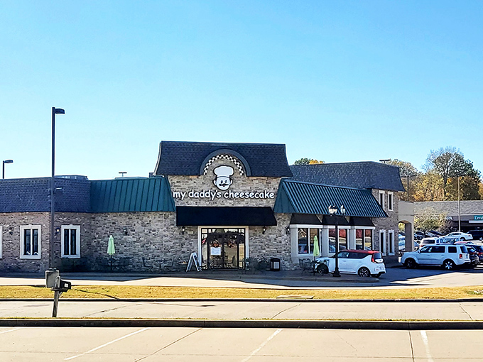 The charming stone facade of My Daddy's Cheesecake welcomes visitors with cheerful green umbrellas and outdoor seating - an irresistible invitation to dessert paradise. 