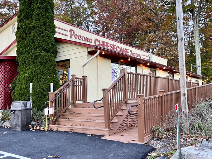 The unassuming exterior of Pocono Cheesecake Factory beckons like a dessert oasis in the woods. Sweet treasures await behind that burgundy sign.