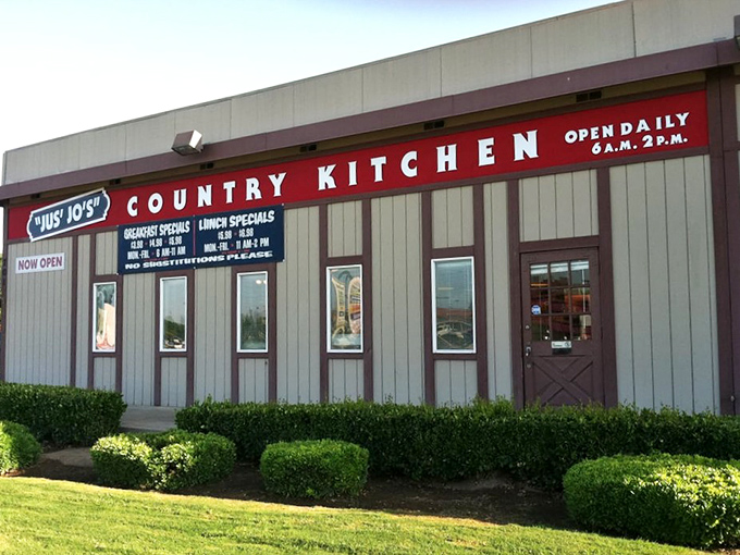 The unassuming exterior of Jus' Jo's Country Kitchen might not stop traffic, but locals know this modest building houses breakfast magic worth the drive.