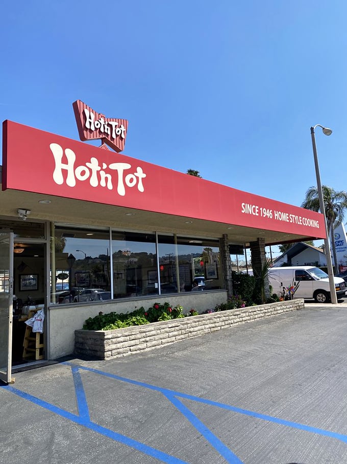 The iconic red awning of Hot N Tot beckons like a lighthouse for hungry souls navigating the Pacific Coast Highway. Classic California diner perfection.