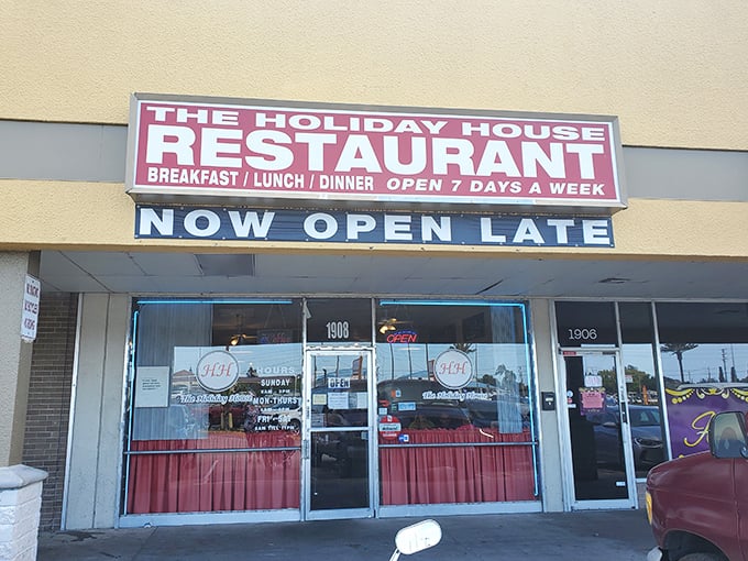 The iconic red curtains and "HH" logo welcome hungry travelers like a beacon of comfort food hope in Holiday, Florida.