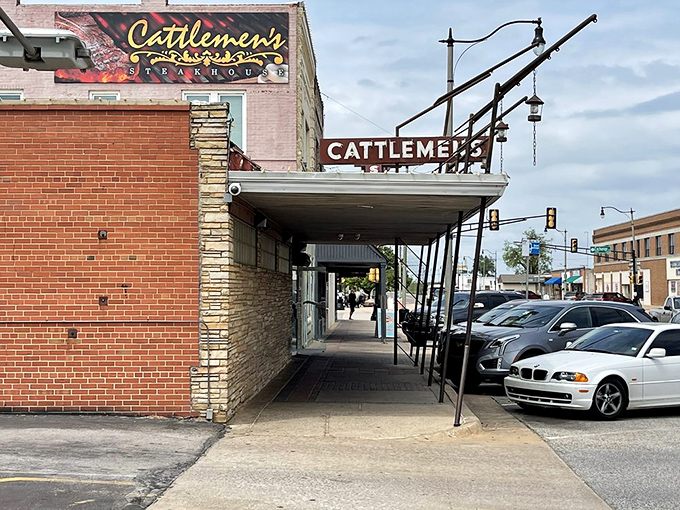 The brick facade of Cattlemen's stands proudly in Oklahoma City's Stockyards, a carnivore's lighthouse beckoning hungry travelers through decades of beef-loving history.