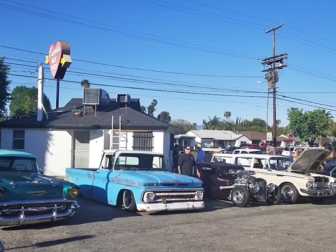 Classic cars line up outside Cupid's Hot Dogs, where automotive nostalgia meets culinary tradition in a perfect Valley pairing.