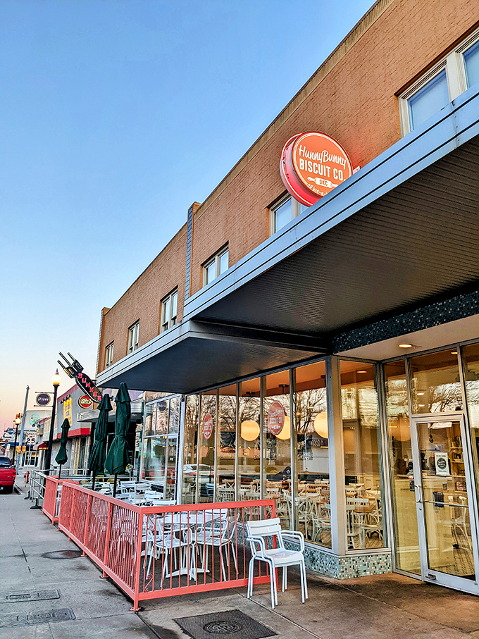 The coral-railed patio at HunnyBunny beckons like a breakfast siren song, with the iconic Tower Theater sign standing guard nearby.