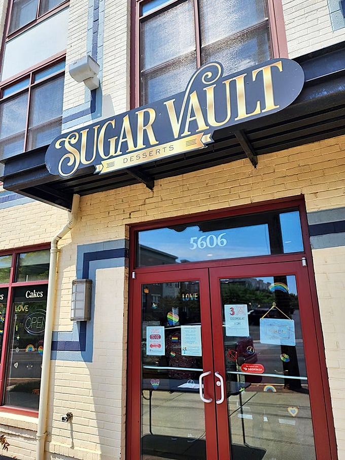 The unassuming storefront of Sugar Vault beckons like a secret treasure map to dessert paradise. Yellow brick, red doors, and sweet promises await.