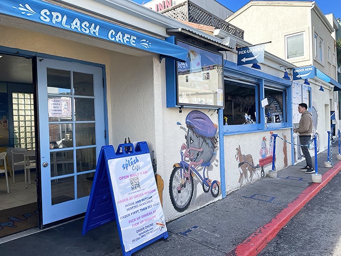 The blue-and-white facade of Splash Cafe stands like a coastal beacon, promising seafood salvation to hungry pilgrims on Pismo Beach's main drag.