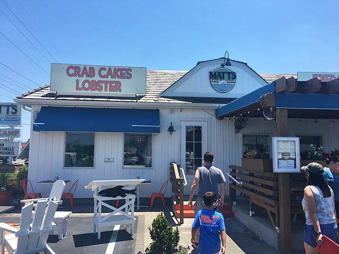 The coastal charm offensive begins! Matt's Fish Camp's white clapboard exterior with its "CRAB CAKES LOBSTER" sign is Delaware's seafood siren call to hungry travelers.