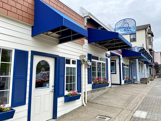The classic coastal charm of The Chowder Bowl welcomes hungry travelers with its bright blue awnings and flower boxes&mdash;seafood paradise found!