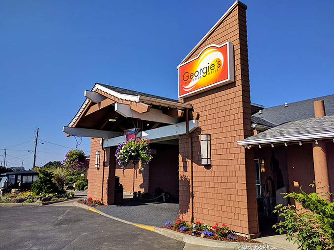Cedar-shingled charm meets coastal elegance at Georgie's entrance, where the promise of seafood treasures awaits just beyond those welcoming doors.