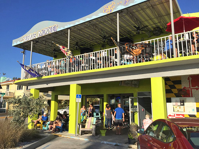 The sunshine-yellow exterior of Brass Monkey stands out like a beacon of culinary hope on St. Pete Beach, promising good times on both levels.