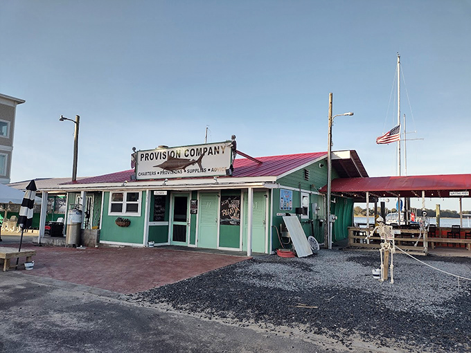 The unassuming entrance to seafood paradise &ndash; where that weathered fish sign promises more flavor than any fancy neon ever could. 