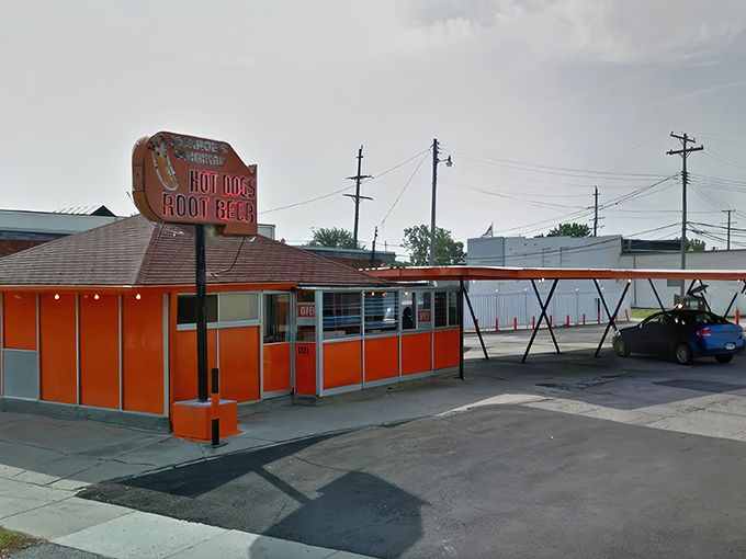 Like a sunset captured in architecture, Monroe's vibrant orange exterior promises something special inside. No fancy frills, just hot dog perfection waiting to happen.