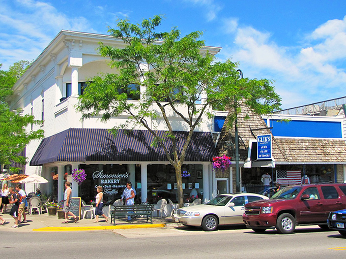 Downtown Charlevoix beckons with its charming storefronts and blue awnings, where Simonsen's Bakery promises sweet treasures worth every calorie.