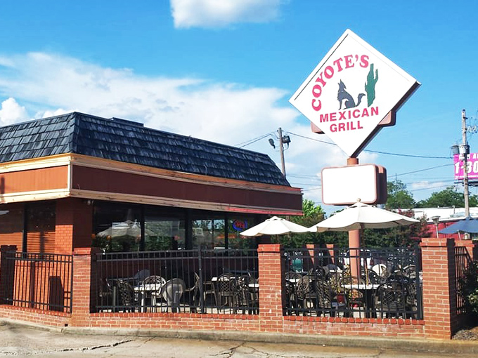 The iconic diamond-shaped sign of Coyote's Mexican Grill stands like a beacon of culinary promise against the Georgia sky. Brick patio, check. Umbrella tables, check. Enchilada paradise, double check.